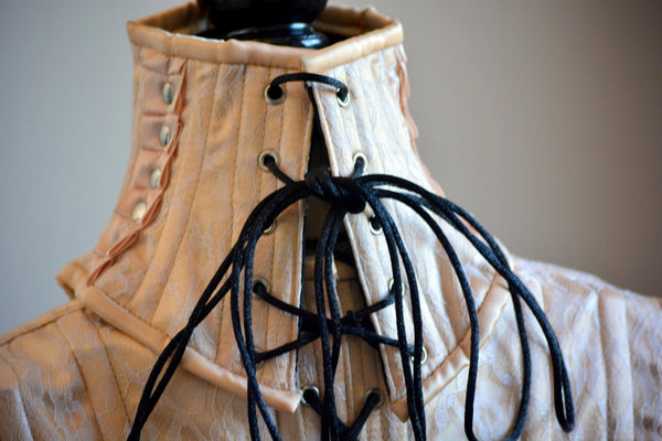 A satin and mesh corsetted collar laced at the back, different colors ...